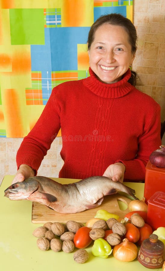 Mature Woman is Cooking Red Fish Stock Image - Image of delicacy, trout ...