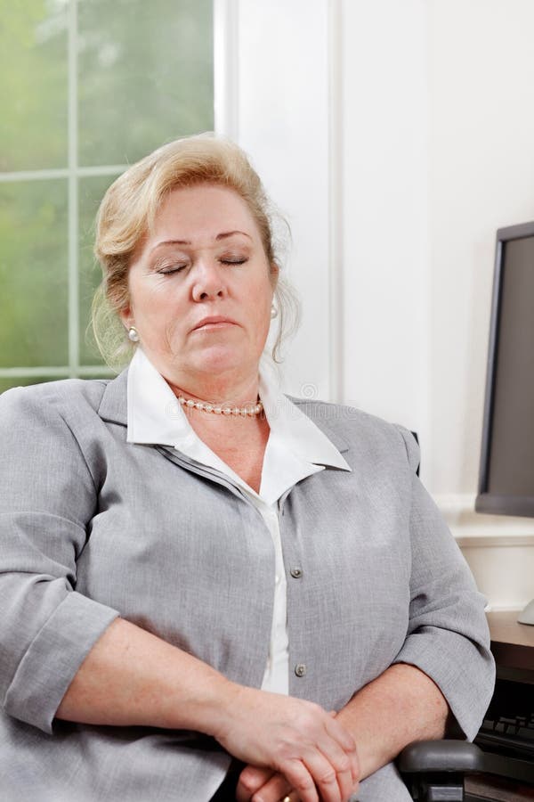 Mature Woman Dozing at the Desk Stock Image - Image of serious, blond ...