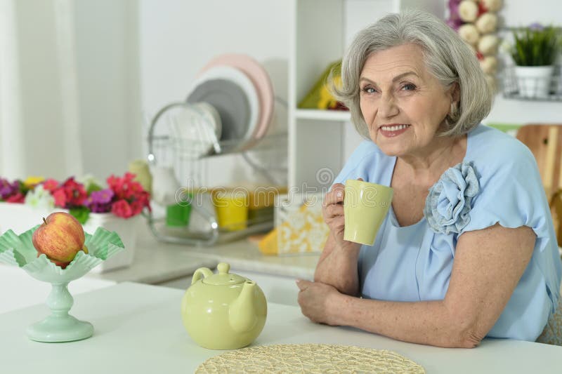 Mature woman drinking tea stock image. Image of senior - 70744539