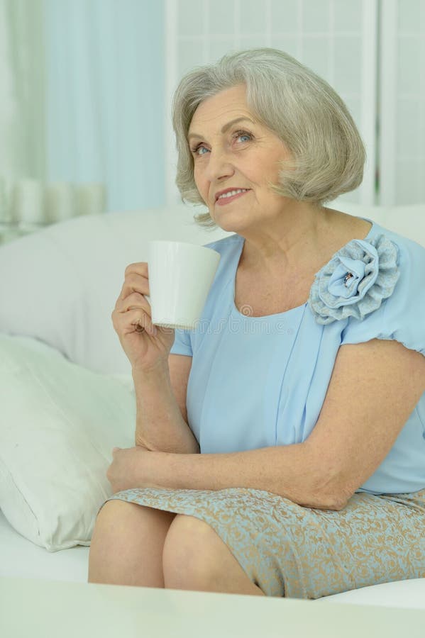 Mature woman drinking tea stock image. Image of retired - 72442931