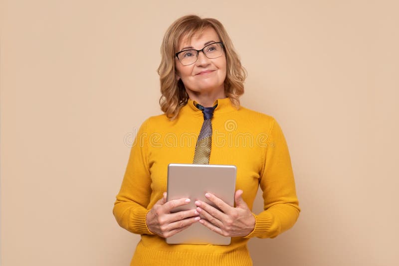 Mature Woman in Glasses Holding Tablet Computer Working on Touching ...