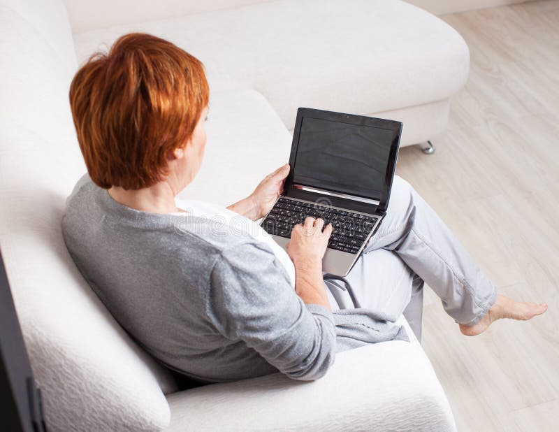 Mature Woman with Laptop Back Stock Photo - Image of home, mobility ...