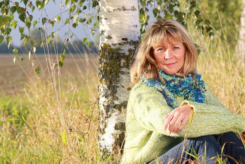 Mature Woman Leaning at Birch Tree Stock Image - Image of elderly, fall ...