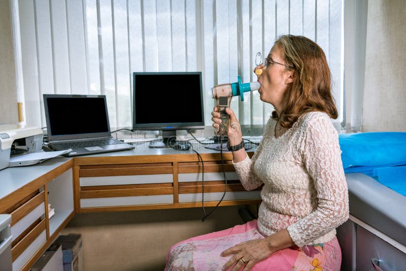 Mature Woman Performing Pulmonary Function Test and Spirometry Stock ...