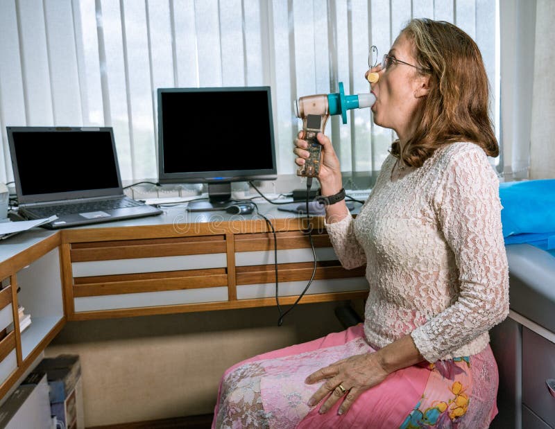 Mature Woman Performing Pulmonary Function Test and Spirometry Stock ...