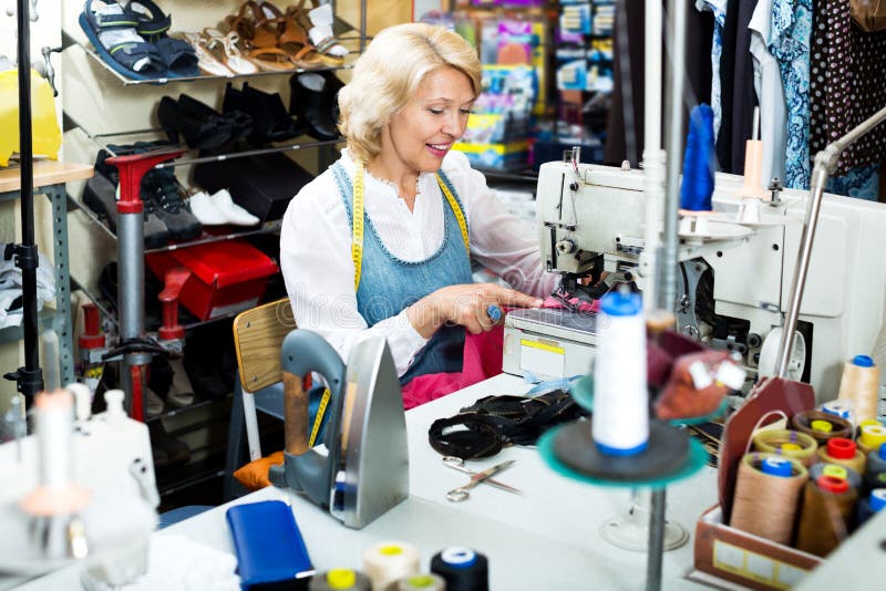 Mature Woman Sewing with Professional Machine Stock Photo - Image of ...