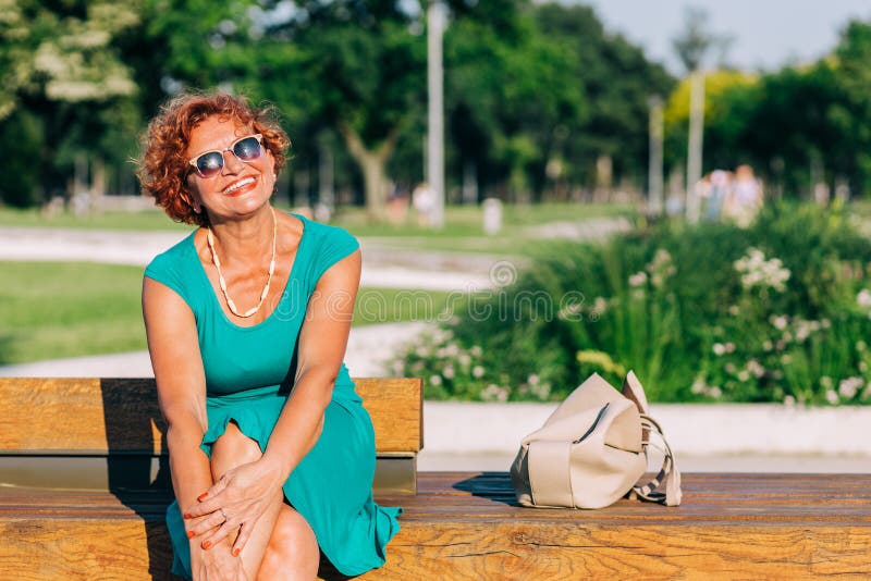 Mature Woman Sitting on the Bench in the Park Stock Photo - Image of ...