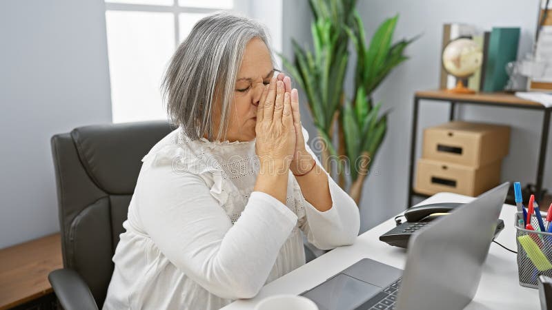 Mature Woman Stressed at Work in a Modern Office, Hands on Face ...