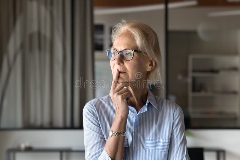 Mature Woman with Thoughtful Expression, Looks into Distance Stock ...
