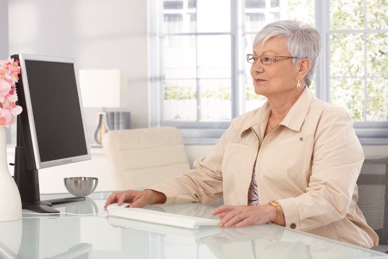 Mature Woman Using Computer Stock Image - Image of browsing, desk: 40569613