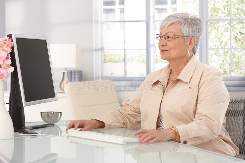 Mature Woman Using Computer Stock Image - Image of browsing, desk: 40569613