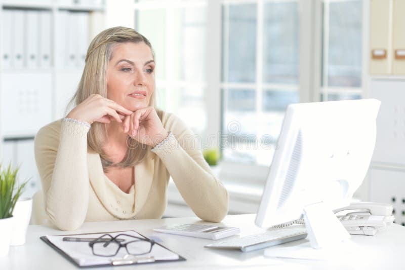 Mature Woman Using Computer Stock Photo - Image of office, employee ...
