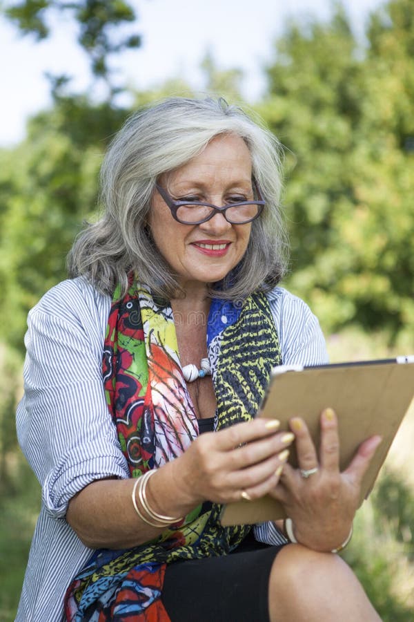 Mature Woman Using Wireless Device Stock Image - Image of communication ...