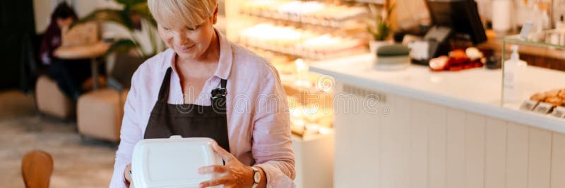 Mature Woman Wearing Apron Working with Takeaway Boxes Stock Image ...