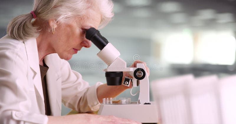 Mature Woman Working in Laboratory Examining Substance through ...