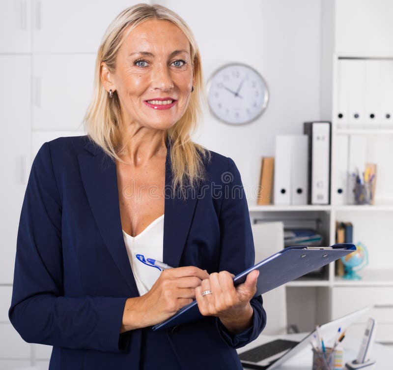 Mature Woman Writing Down Tasks Stock Photo - Image of workplace ...
