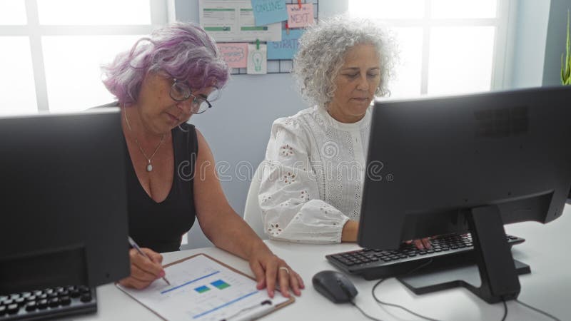 Mature Women Working in an Office, Collaborating on a Project with ...