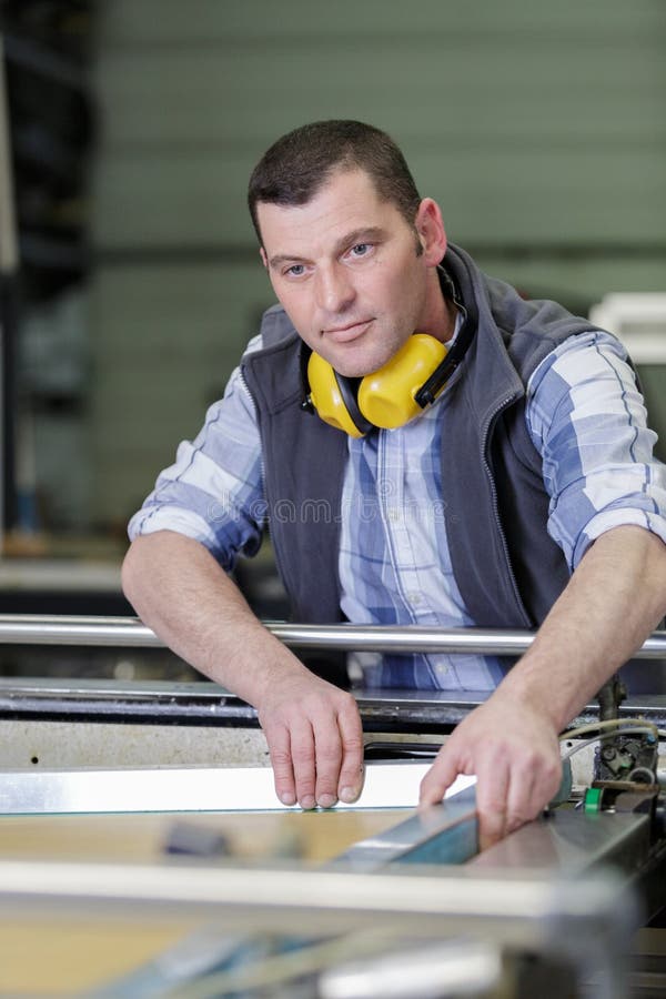 Mature Worker Adjusting Machinery in Factory Stock Photo - Image of ...