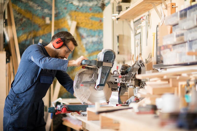 Mature Worker Cutting Wood stock photo. Image of woodwork - 133397808