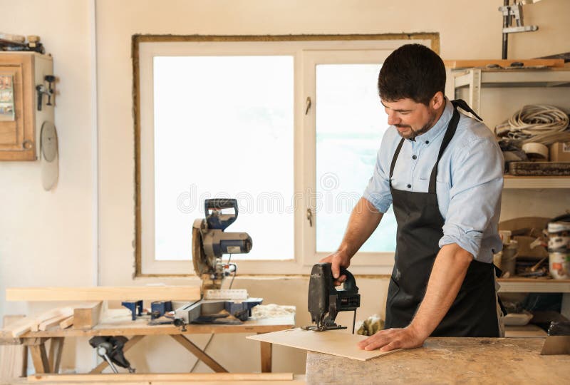 Mature Working Man Using Jigsaw at Carpentry Shop Stock Image - Image ...