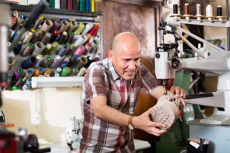 Mature Workman Sewing Leather Boots on Stitch Lathe Stock Photo - Image ...