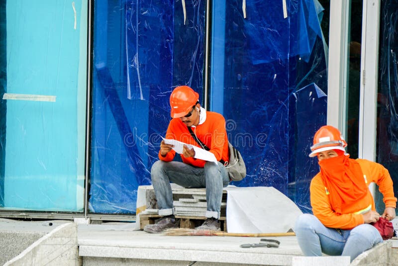 Thai Construction Engineer Reading Construction Plan with Another One ...