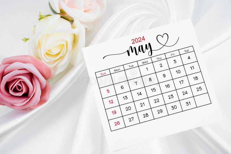 The May 2024 Calendar Page and Rose Flower on White Satin Textile ...