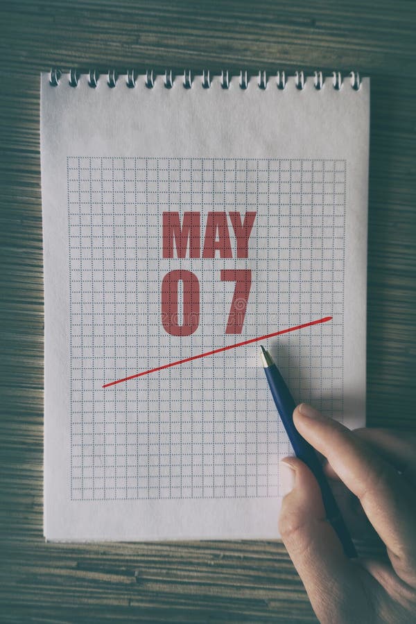 May 7th. Day 7 of Month, Close Up of Human Hand with Pen on Notepad ...