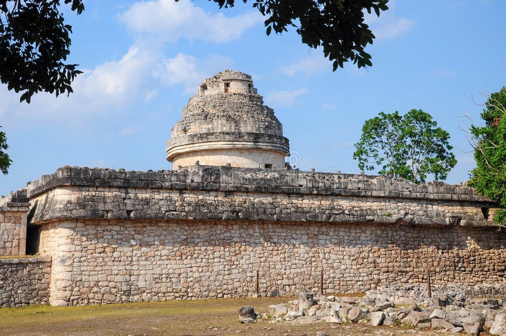 Mayan Observatory at Chichen Itza with Greenery and Clear Blue Sky ...