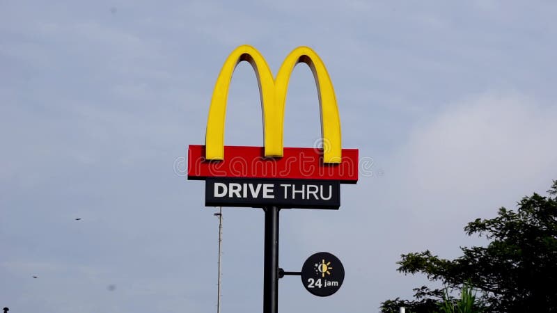 A Mcd (McDonald S) Logo Displayed on a Light Box Pole with a Drive-thru ...