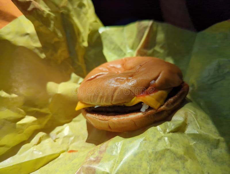 McDonald S Single Cheeseburger with Yellow Wrapping Stock Image - Image ...