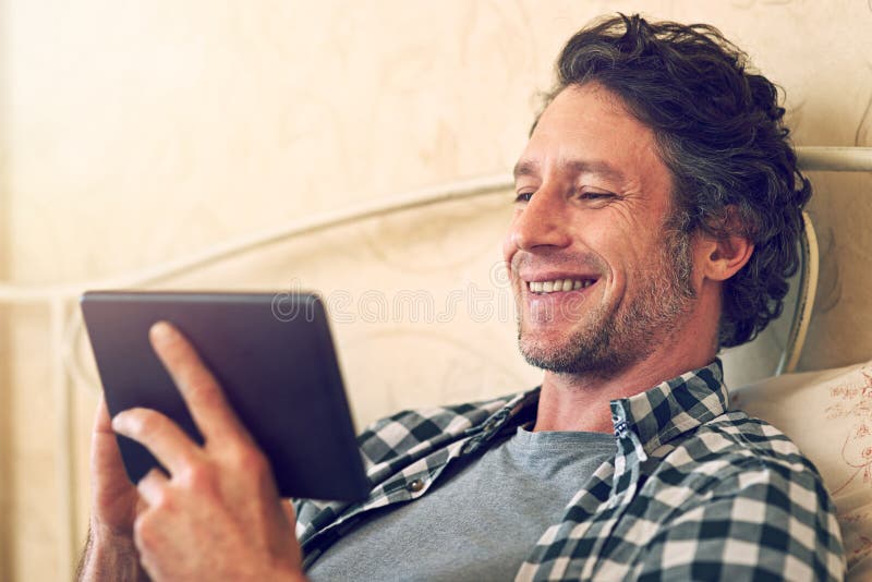 Me Time, Online. a Man Working on His Tablet in Bed. Stock Image ...