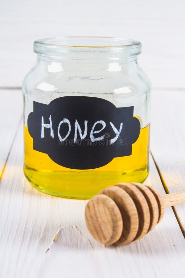 Mead Jar Labeled Honey with a Dripper, on a White Table. Stock Image ...