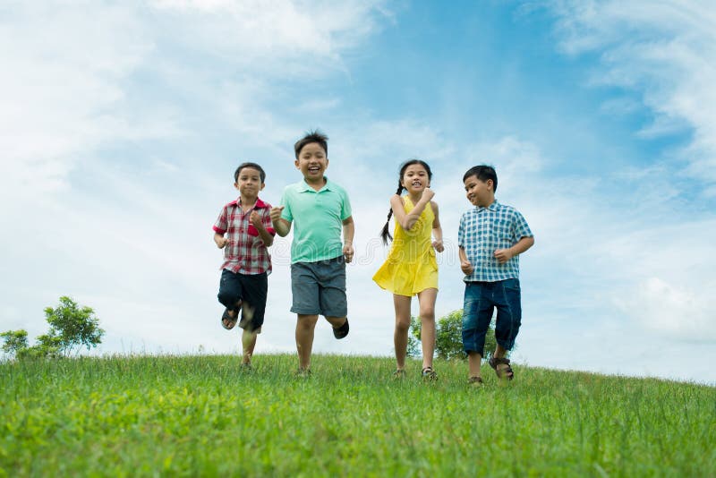 Excited Running Kids in Green Field Play Together Stock Image - Image ...
