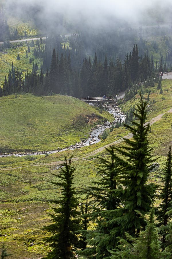 Meadow with River Bridge and Hikers Seen from High Above Stock Photo ...