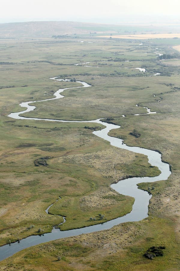 A Meandering Stream Twisting and Turning through a Flat Meadow. Stock ...