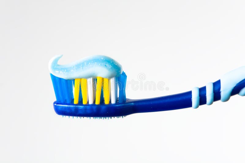 Blue Toothbrush with Blue Toothpaste on a Light Background. Stock Photo ...