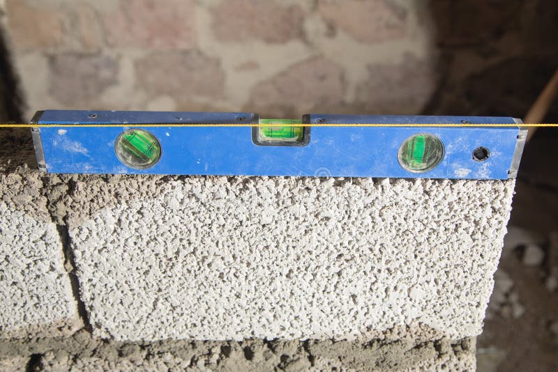 Measure Level on Brick Wall in Construction Site Stock Photo - Image of ...
