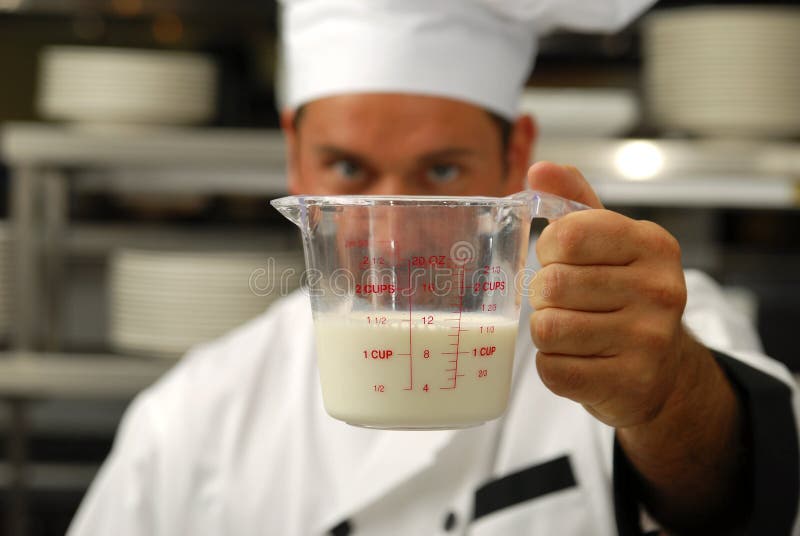 Measure the milk stock image. Image of cook, uniform - 11987307
