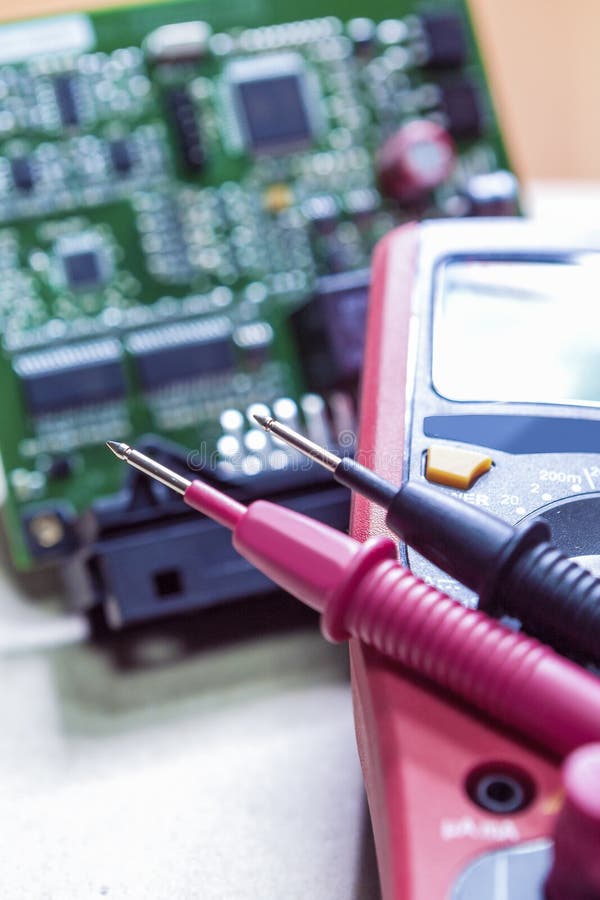 Measurement Pins of Digital Multimeter Tester Against of Pinted Stock ...