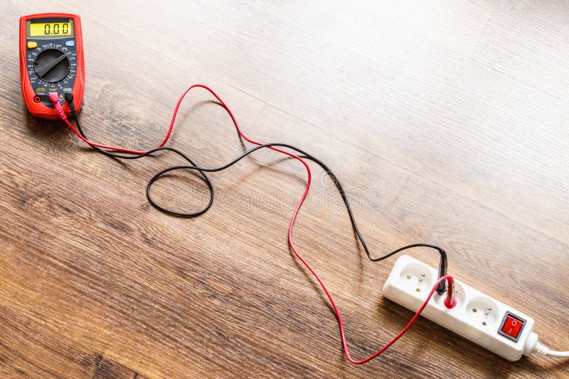 Measurement Voltage in Electrical Socket with Multimeter Stock Photo ...