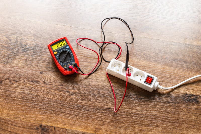 Measurement Voltage in Electrical Socket with Multimeter Stock Photo ...