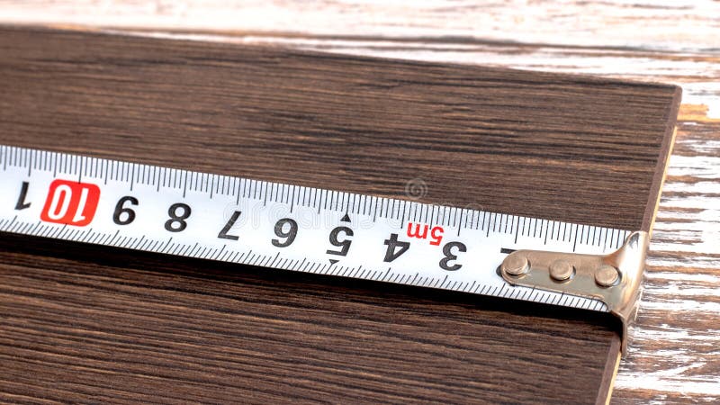 Measuring the Board with a Tape Measure Stock Image - Image of ...