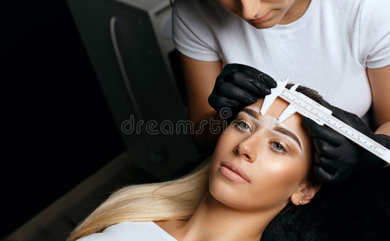 Measuring with Calipers before Permanent Makeup Stock Image - Image of ...