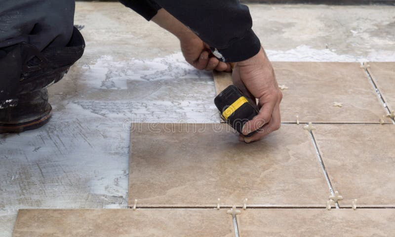 Measuring a Ceramic Tile As he Prepares To Install Them Stock Photo ...