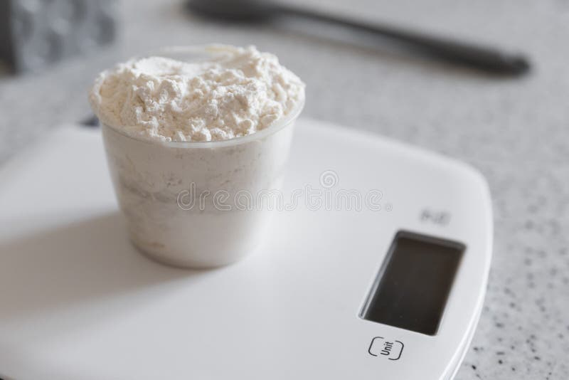 Measuring Cup with Flour on a White Kitchen Scale Stock Photo - Image ...