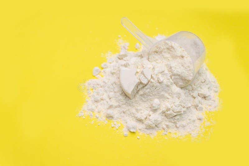 Measuring Cup from a White Powder Whey Protein on a Yellow Background ...