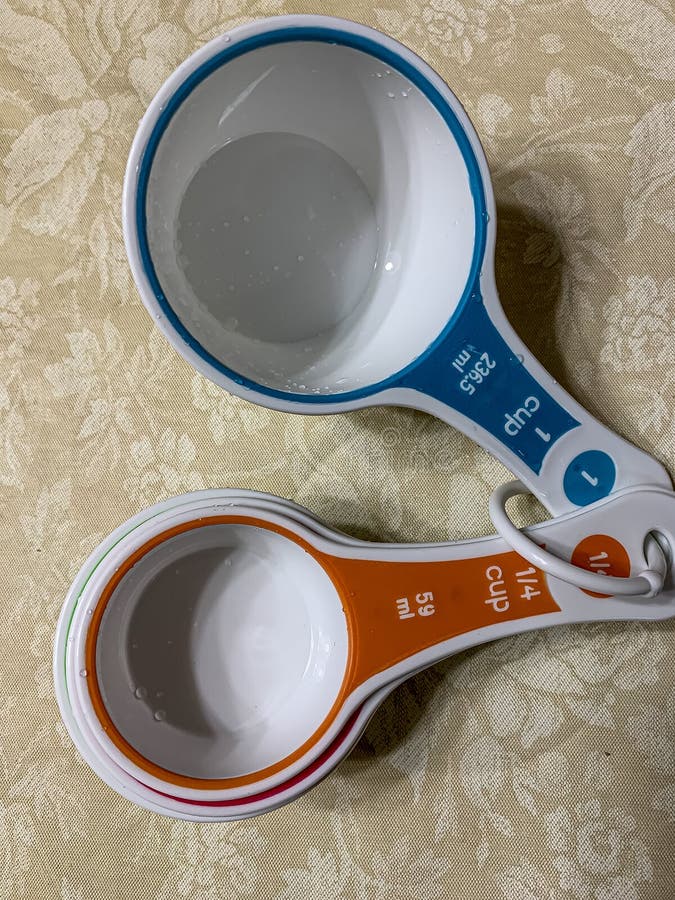 Four Measuring Jugs Full Of Coloured Liquids Stock Image - Image of ...