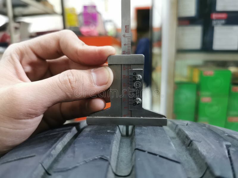 Measuring deep thread tire stock photo. Image of gadget - 261776602