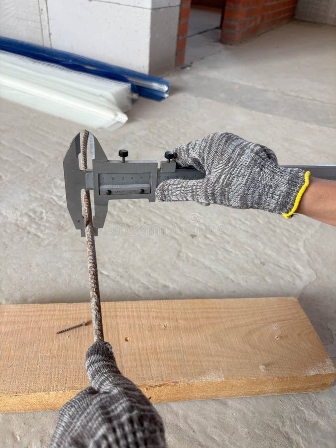 Measuring the Diameter of Reinforcement Using a Caliper. Workers Hands ...
